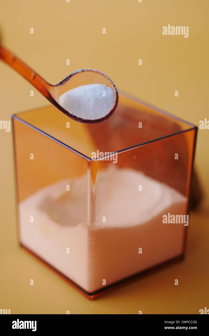 spoon pick salt from a container Stock Photo - Alamy