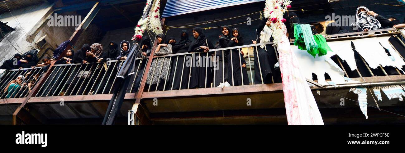 Shia women looking down at the religious procession around the Iranian ...