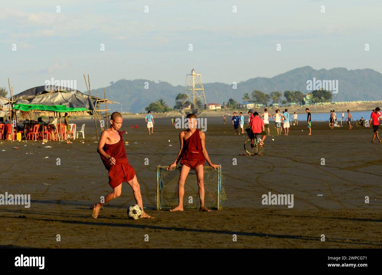 Arakanese Buddhist monks playing football on beach in Sittwe, Rakhine ...