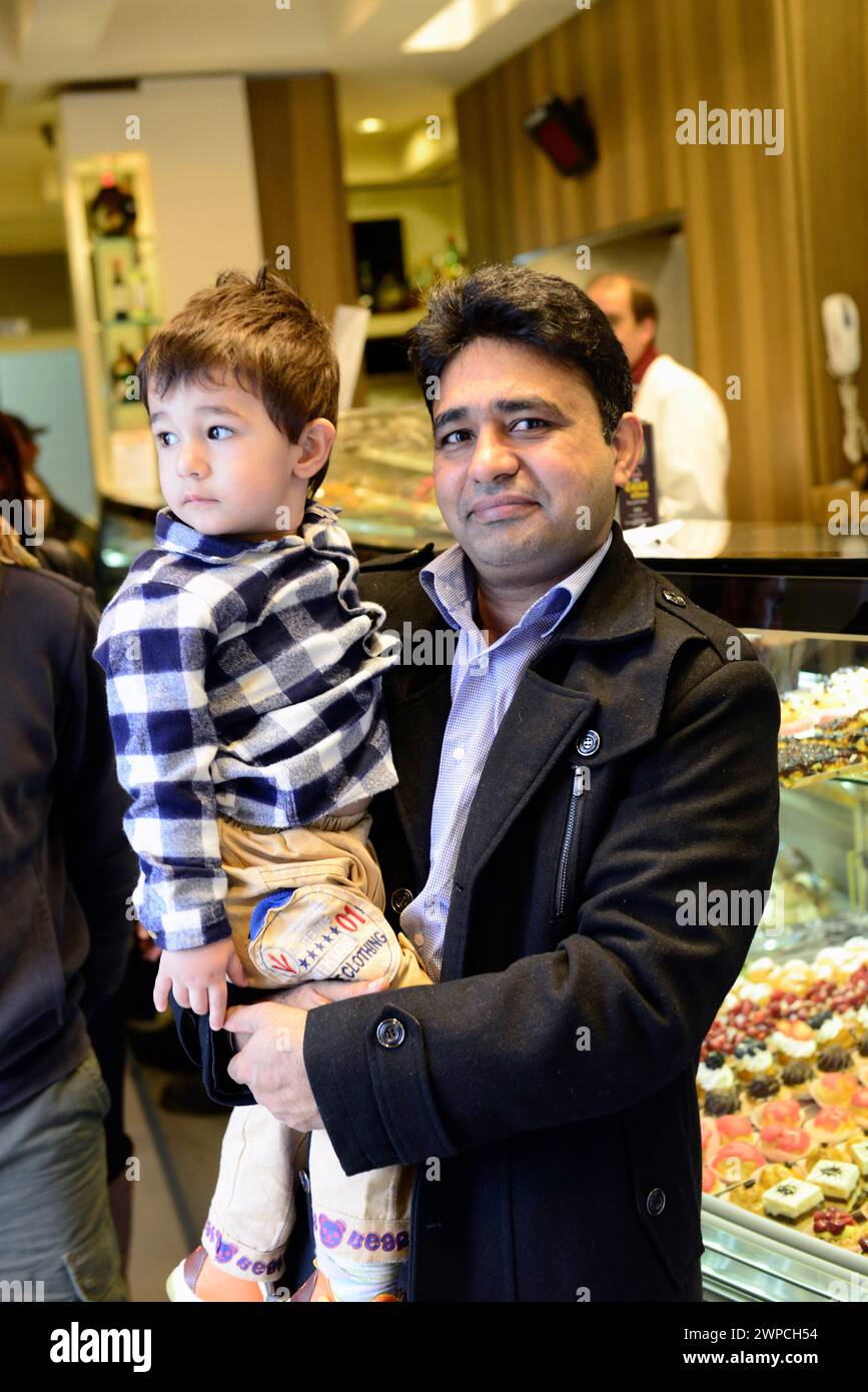 A Sicilian father holding his son at Bar Touring in Palermo, Sicily ...
