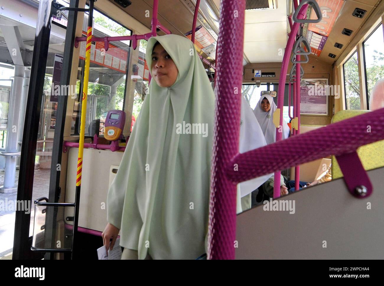 Muslim passengers on a public bus in Singapore Stock Photo - Alamy