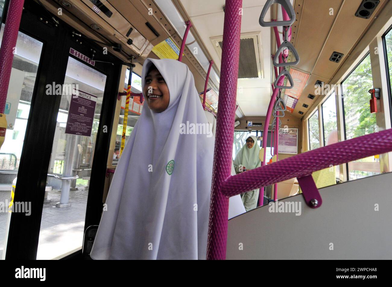 Muslim passengers on a public bus in Singapore Stock Photo - Alamy