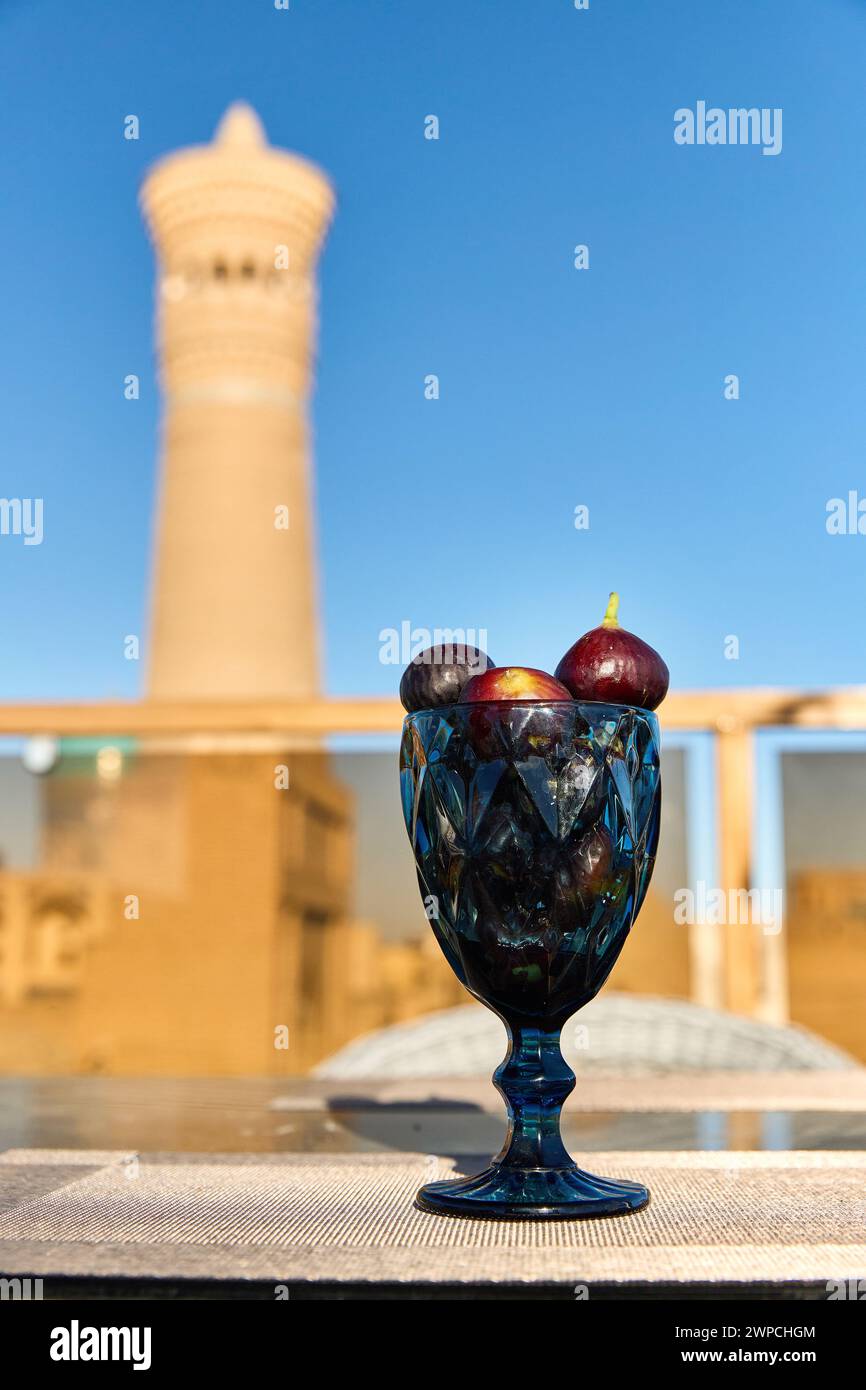 Still life of glass full of figs at table of roof top restaurant in ...