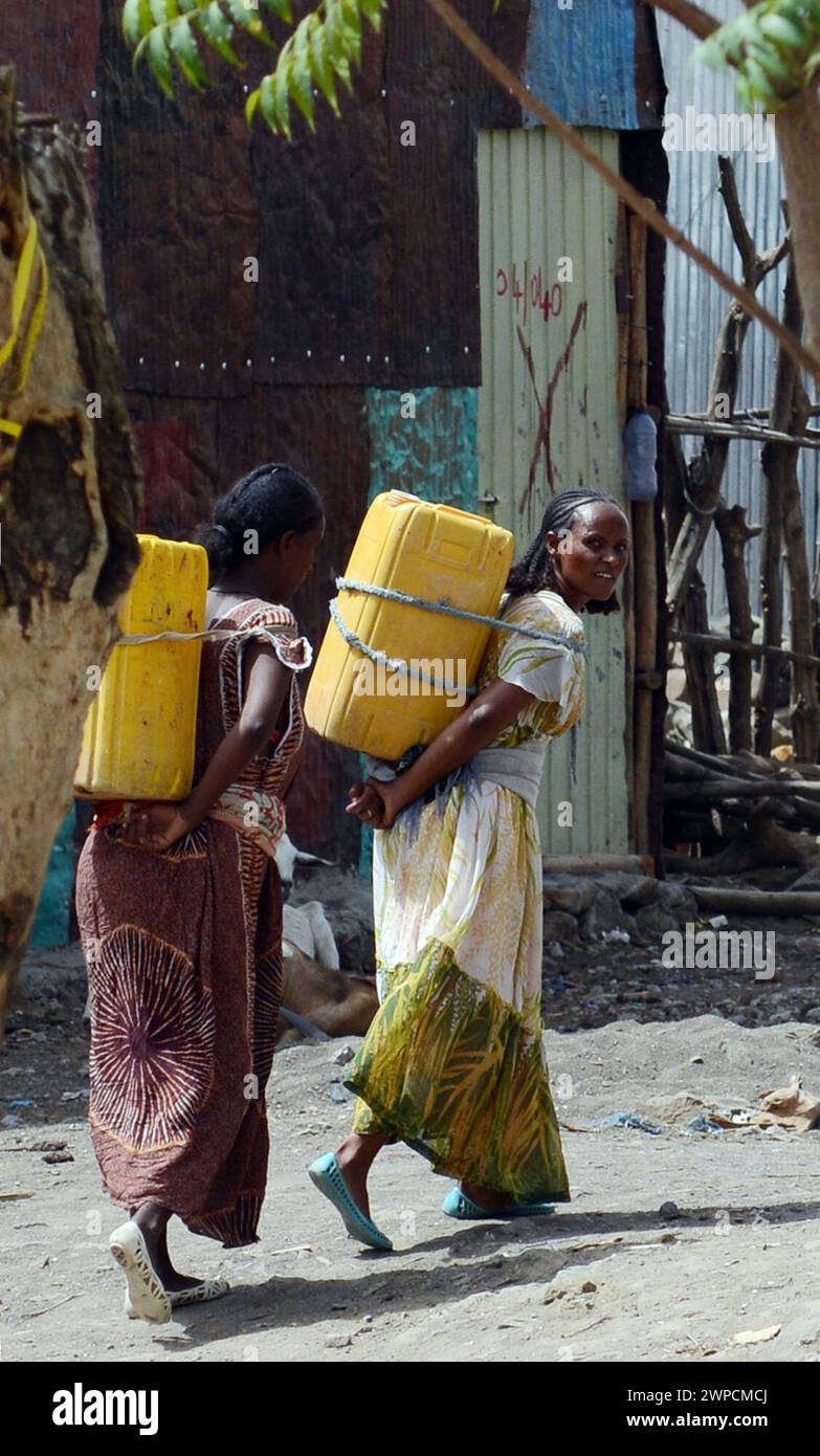 Tigrayan women carrying water to their village in large jerrycans ...