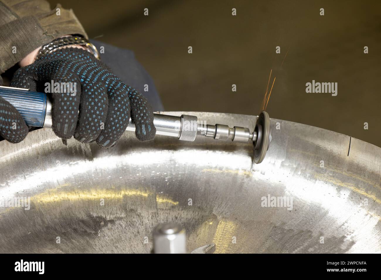 The mechanic is using a grinding machine Stock Photo - Alamy