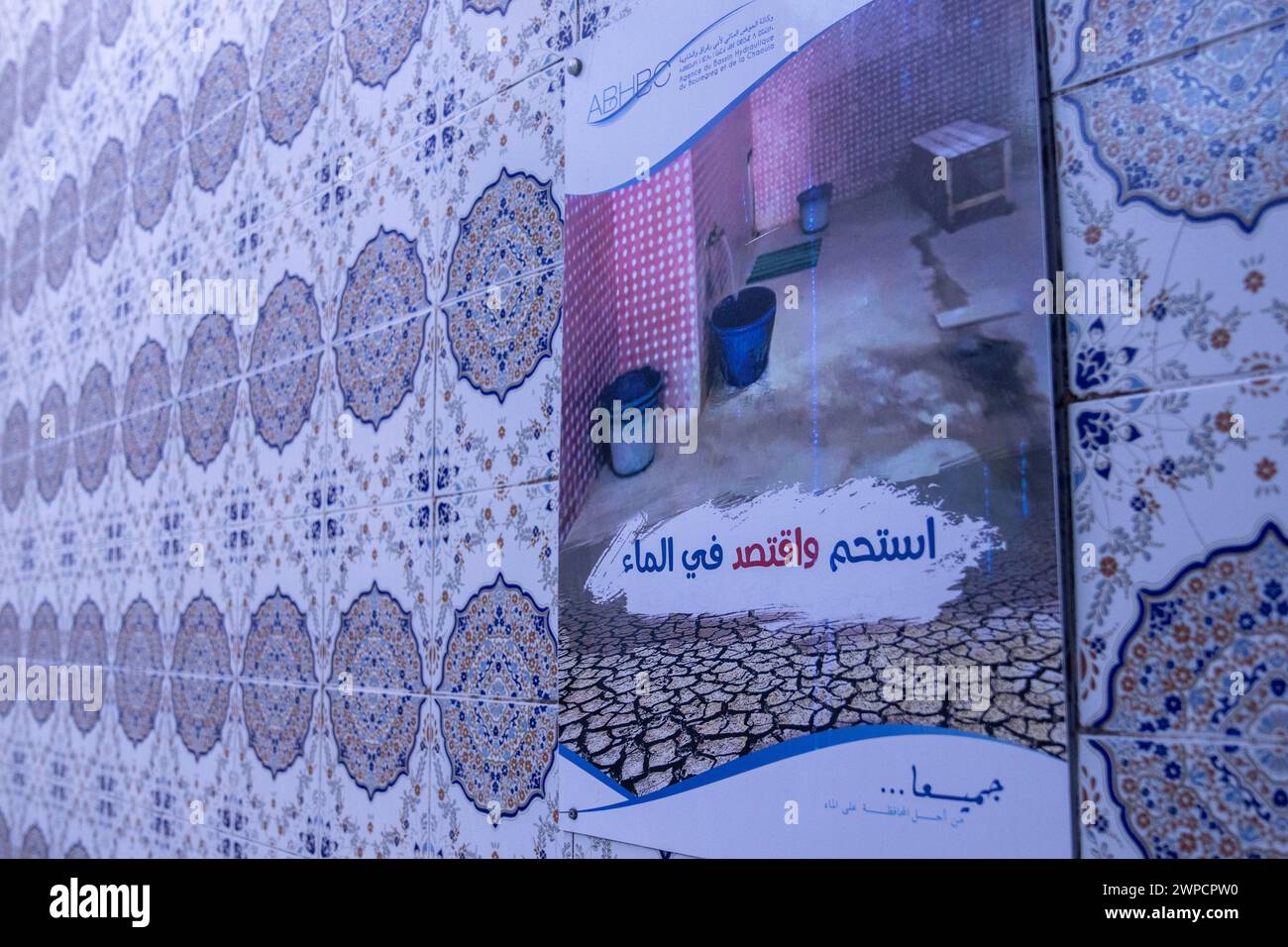 A notice poster encourages people to preserve water inside a Moroccan ...