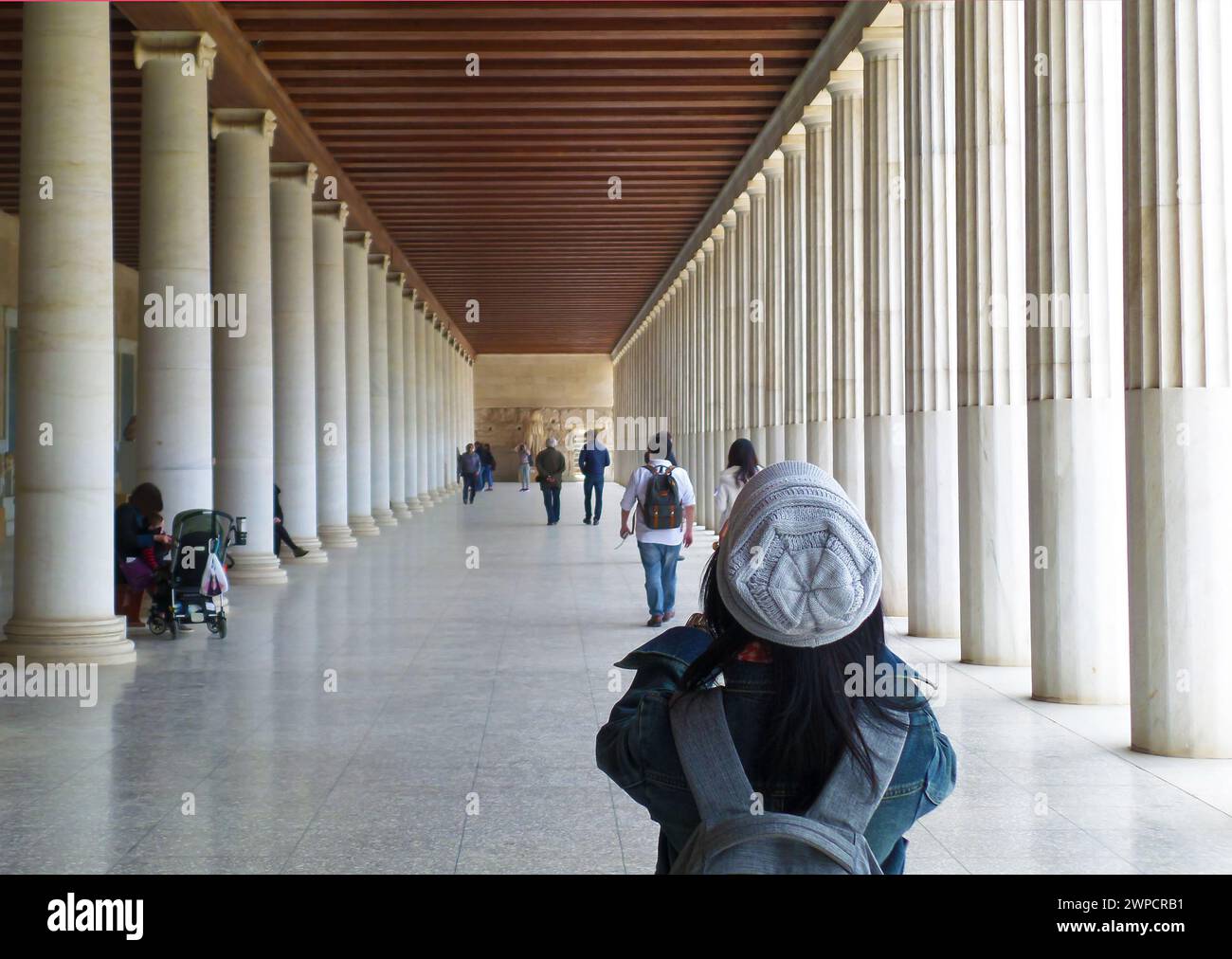 Visitor in a Corridor with Rows of Massive Columns of Stoa of Attalos ...