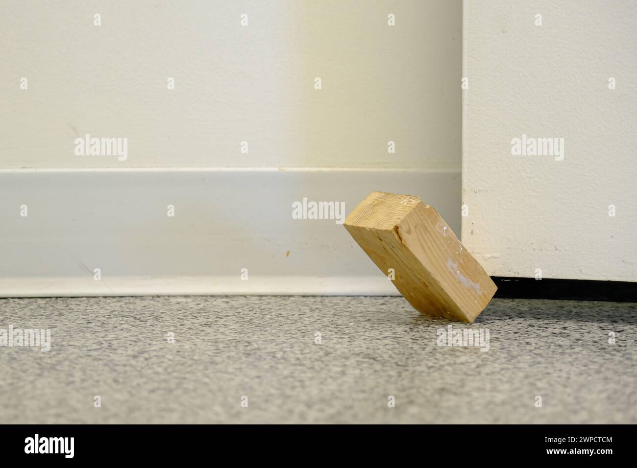Wood Door Wedge hold a door open Stock Photo - Alamy