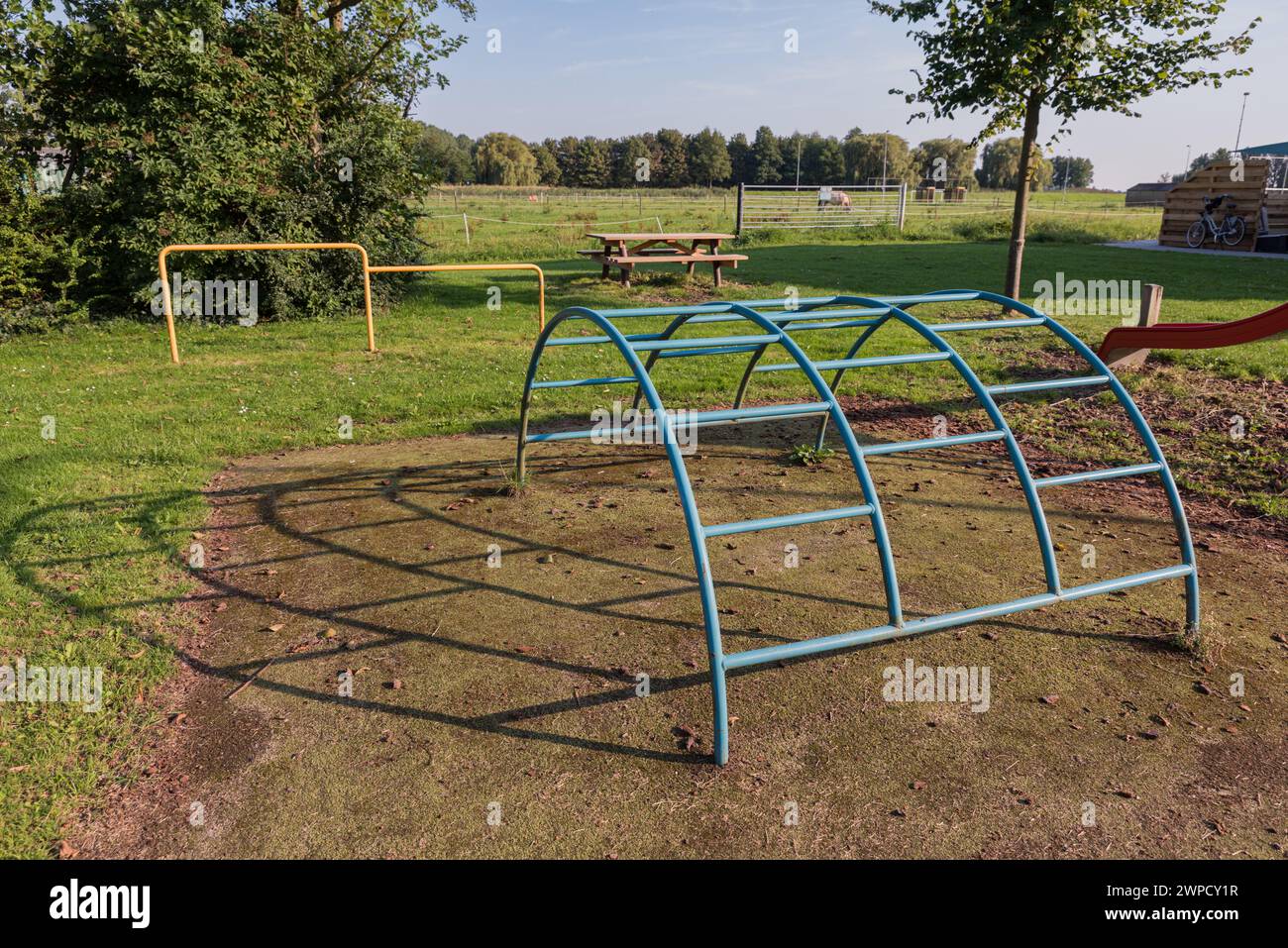 A blue climbing ladder arch in a children's playground Stock Photo - Alamy