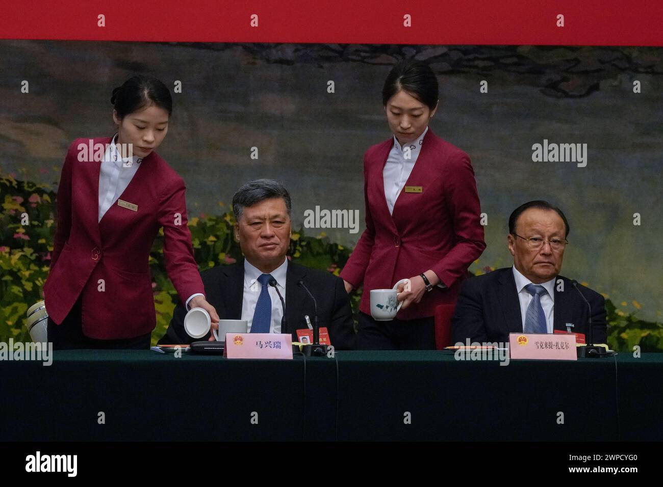 Hostesses refill drinking cups for Xinjiang delegations as Ma Xingrui ...