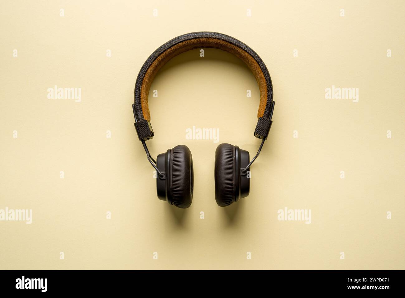 Retro style wireless over-ear headphones on yellow background Stock ...