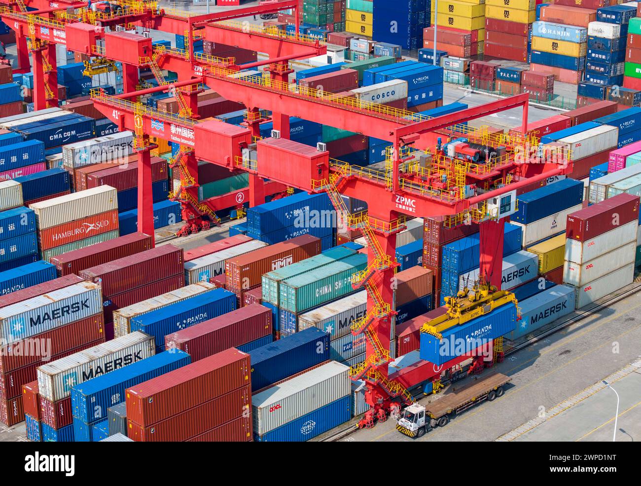 TAIZHOU, CHINA - MARCH 7, 2024 - Transport vehicles transfer containers ...