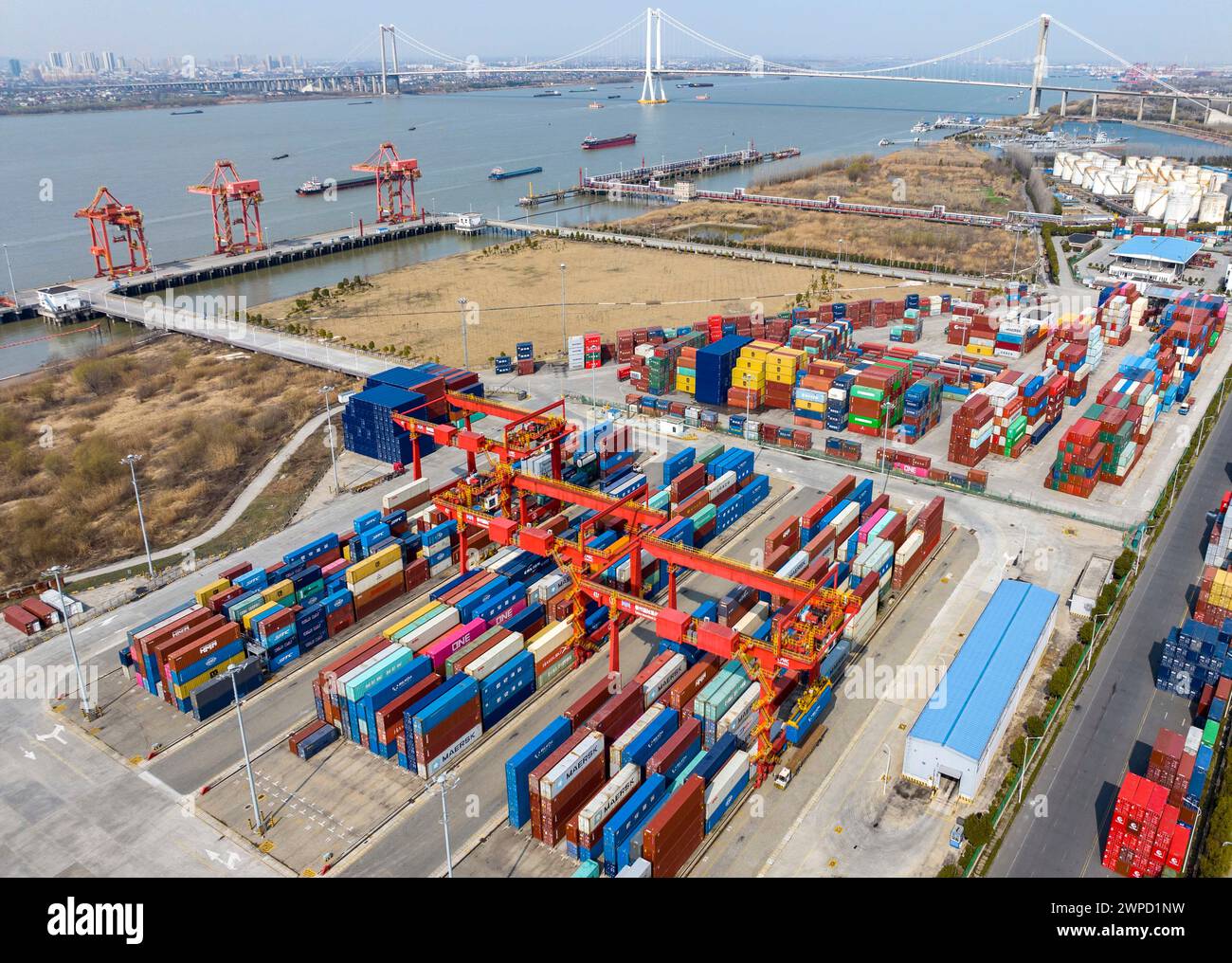 TAIZHOU, CHINA - MARCH 7, 2024 - Transport vehicles transfer containers ...