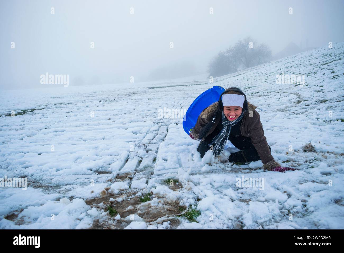 A Filipino Female Having Fun Sledging for the first time in the UK Snow ...