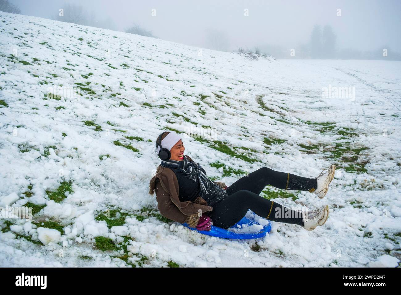 A Filipino Female Having Fun Sledging for the first time in the UK Snow ...