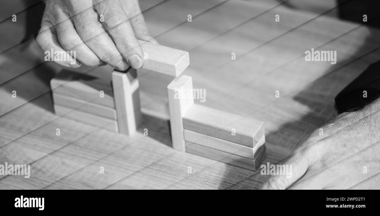 Male hand building a bridge with wooden blocks; concept of association ...