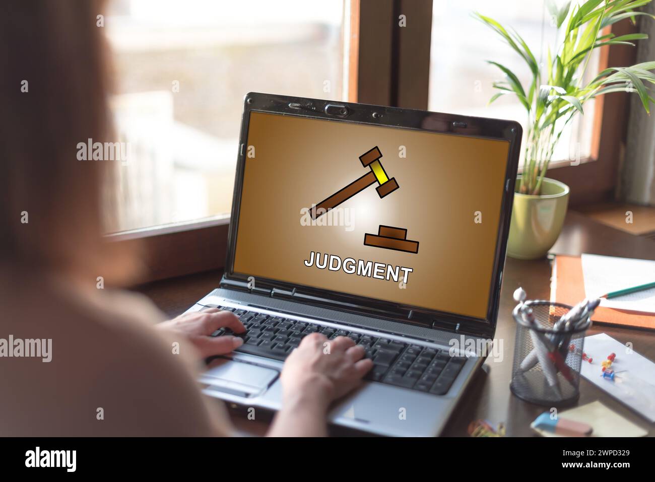 Laptop screen displaying a judgment concept Stock Photo - Alamy