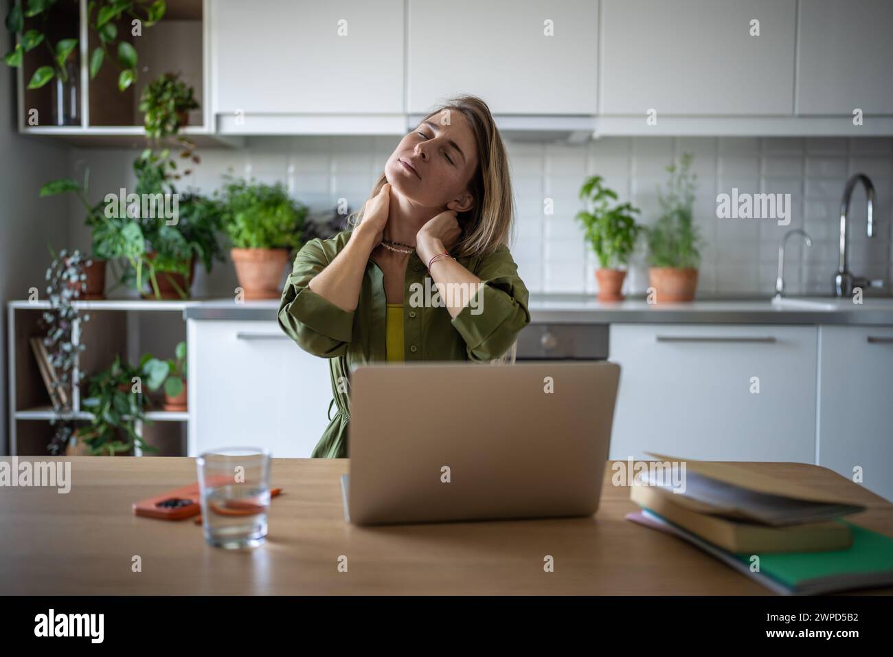 Overworked female relaxing, stretching muscles, massaging neck after ...