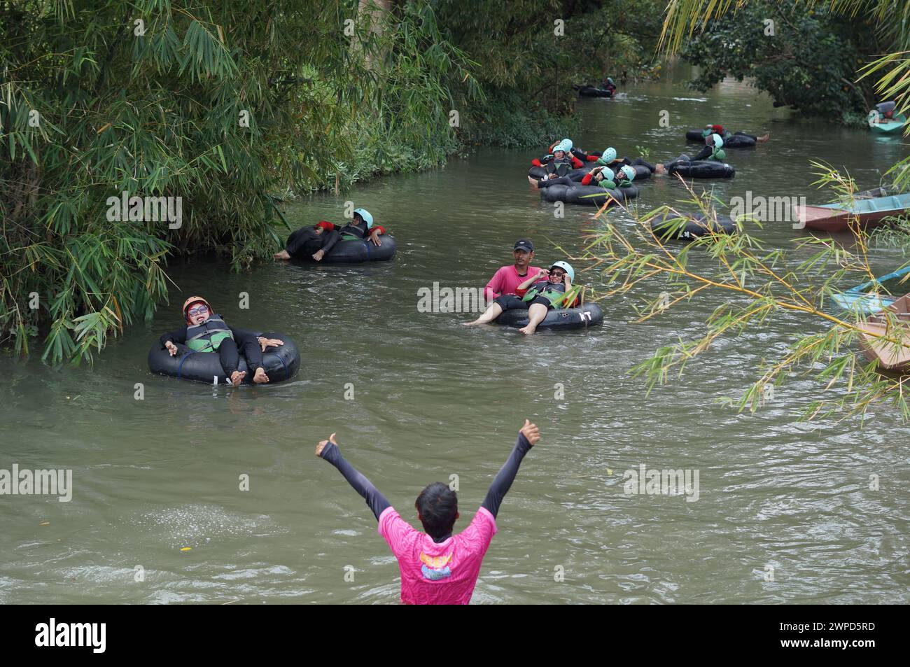 Tourists tubing on Muncul river in Semarang regency, Indonesia - March ...