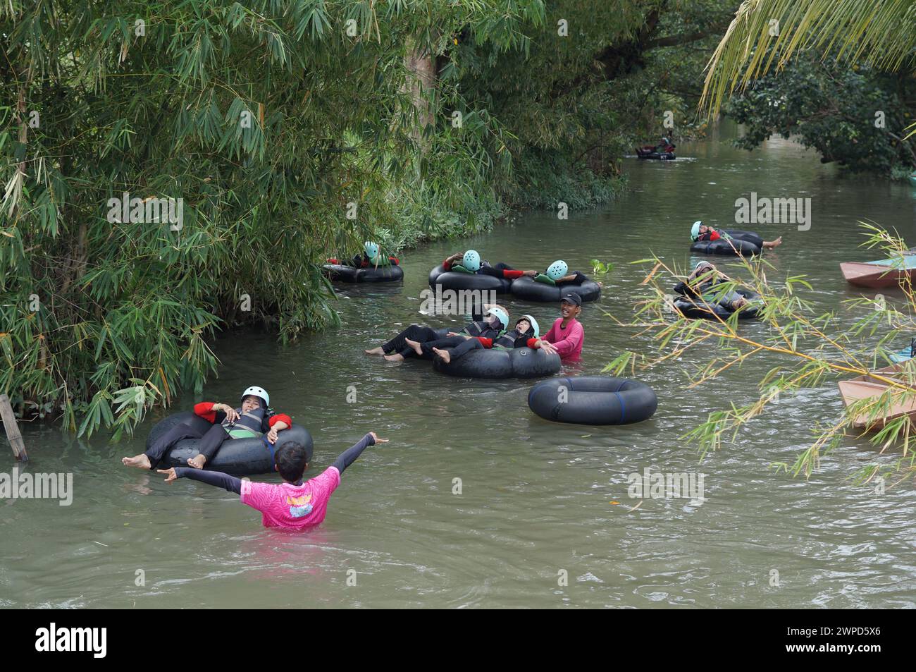 Tourists tubing on Muncul river in Semarang regency, Indonesia - March ...