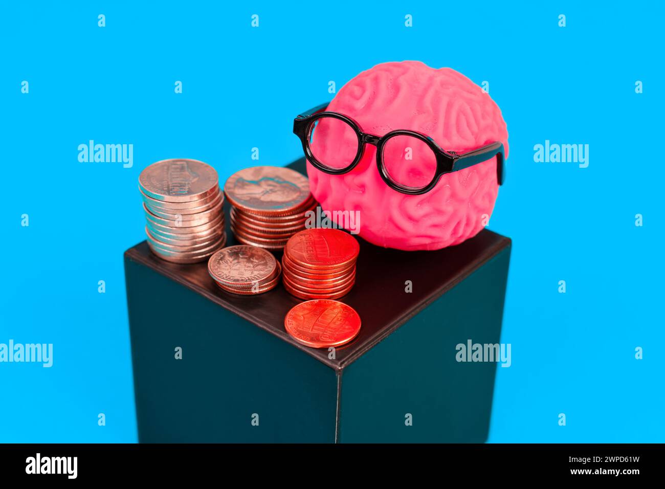 Human brain character wearing glasses sits at a desk with stacks of ...