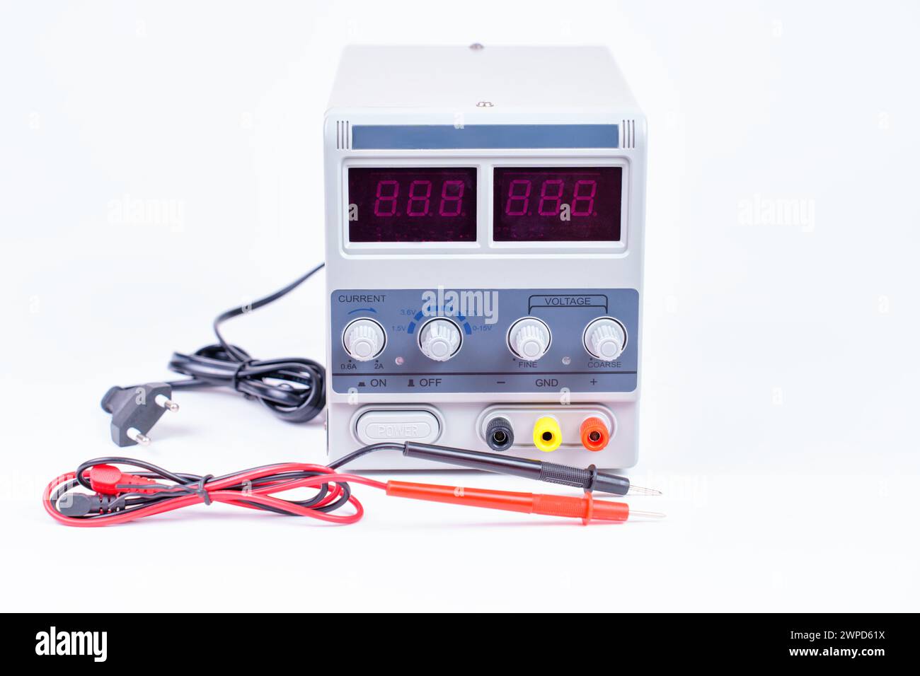 Front view of a laboratory DC power supply unit with leads and wires ...
