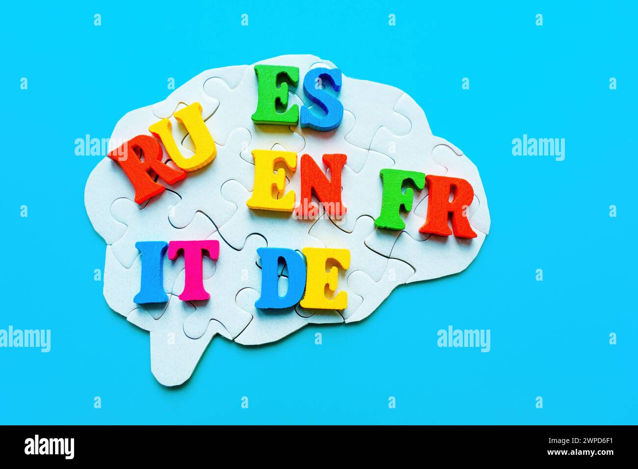 Brain-shaped puzzle adorned with vibrant wooden letters representing ...