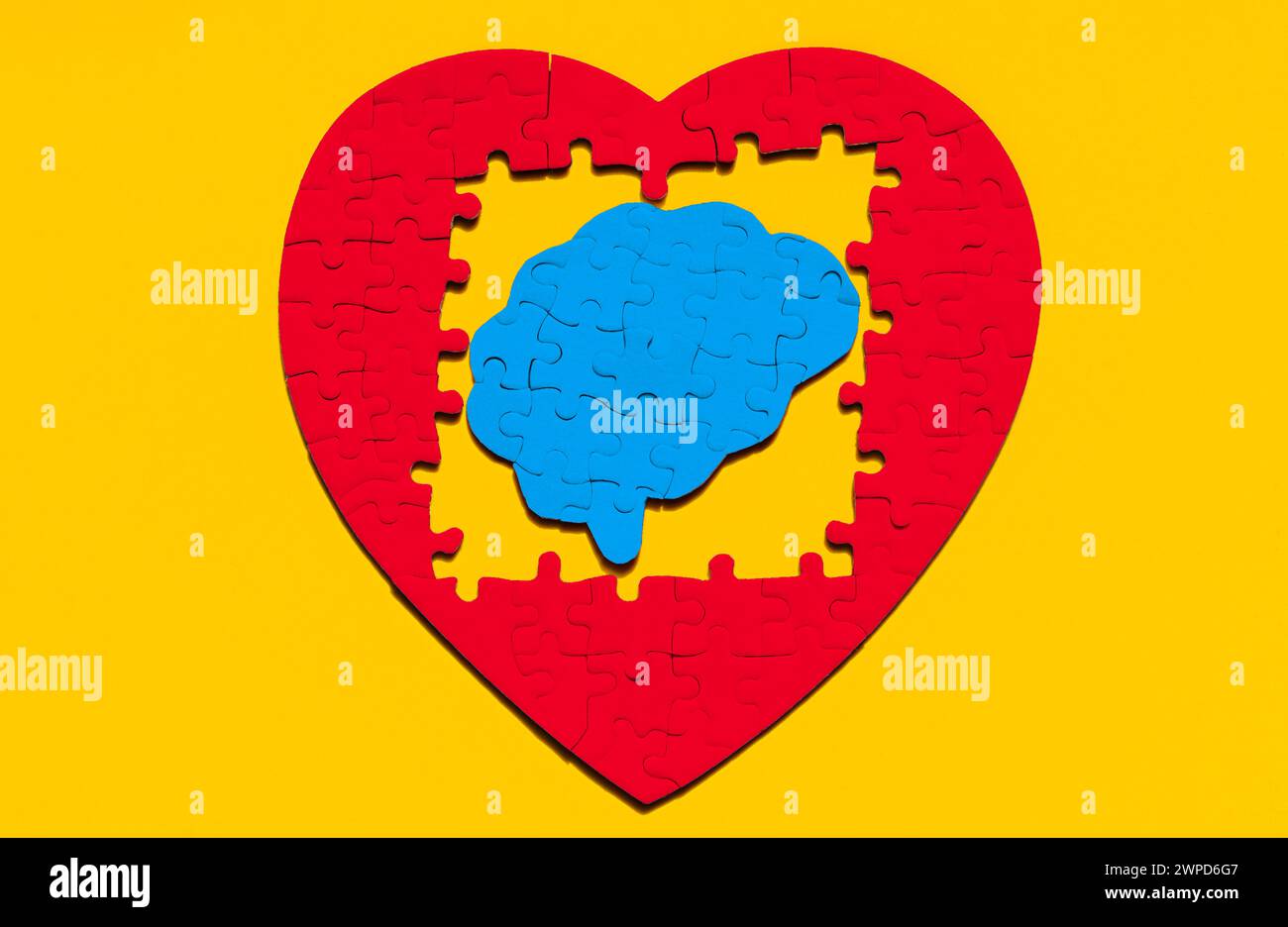 Heart-shaped puzzle frame enclosing a brain puzzle piece, set against a ...