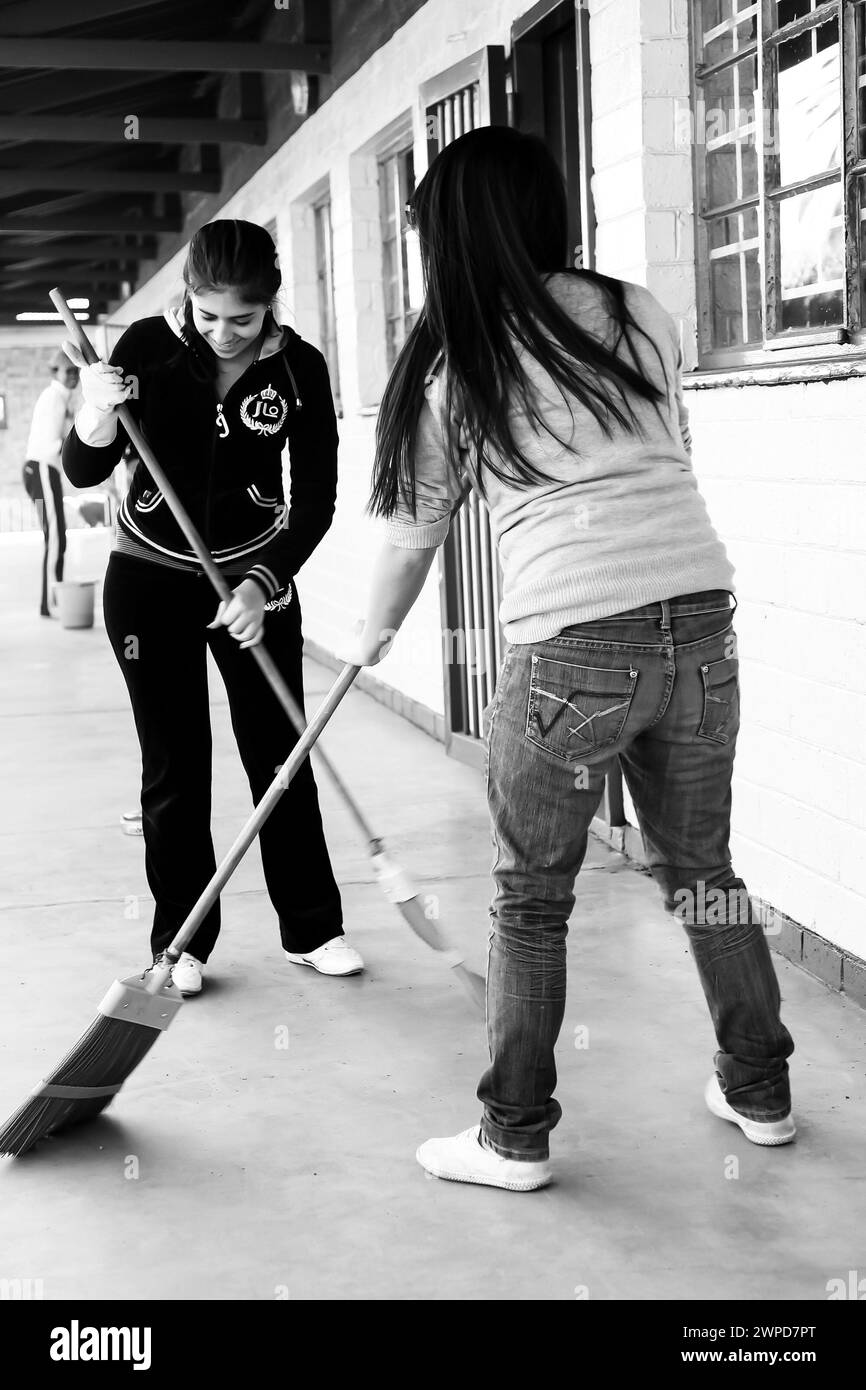 A grayscale of women mopping floor in Johannesburg, South Africa Stock ...