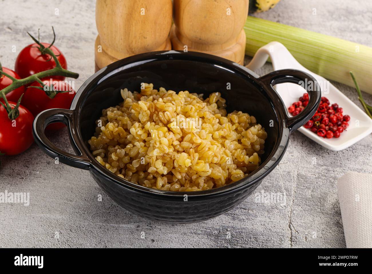 Boiled bulgur wheat in the bowl garnish Stock Photo - Alamy