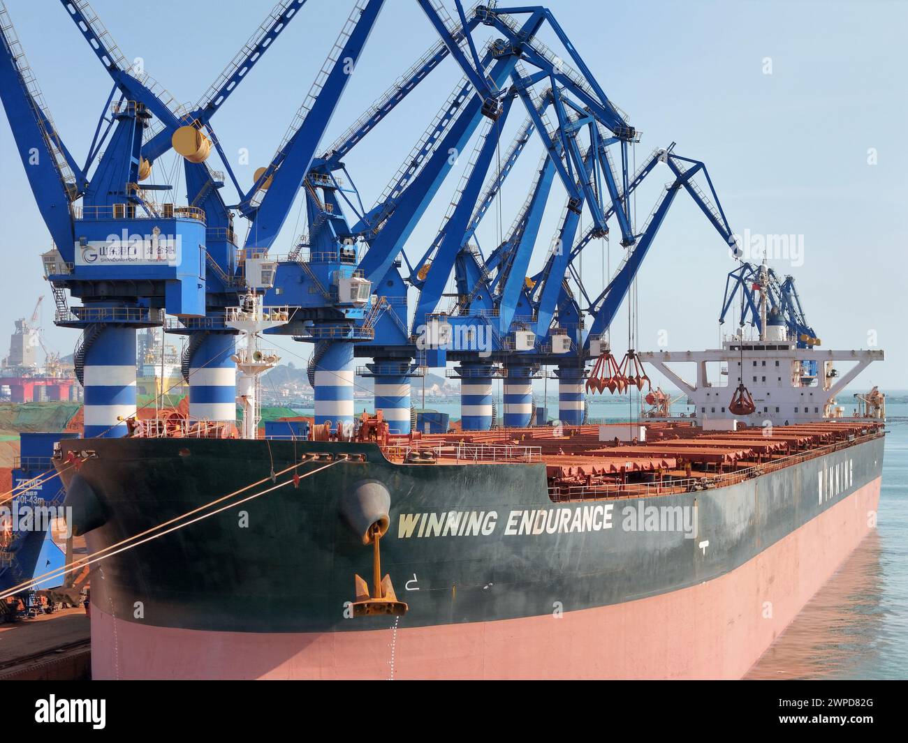 YANTAI, CHINA - MARCH 6, 2024 - Cargo ships unload bauxite at the port ...