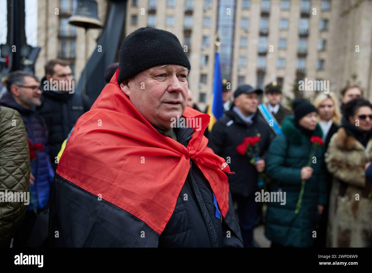 Ukrainian man wearing a red and black nationalist flag as the symbol of ...