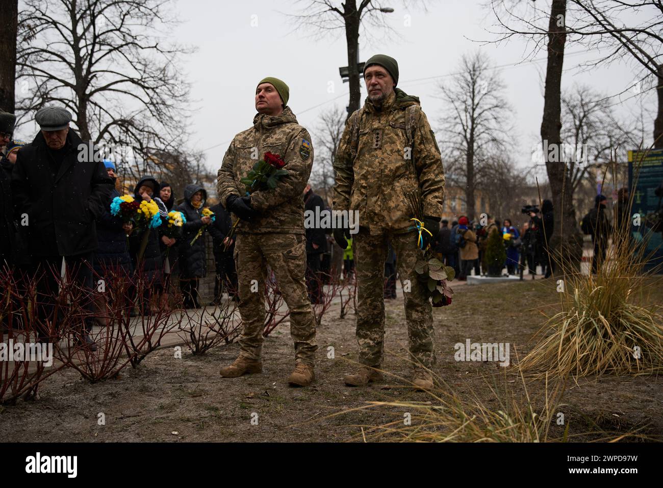 Ukrainian soldiers bring flowers at the ceremony on the Day of the ...