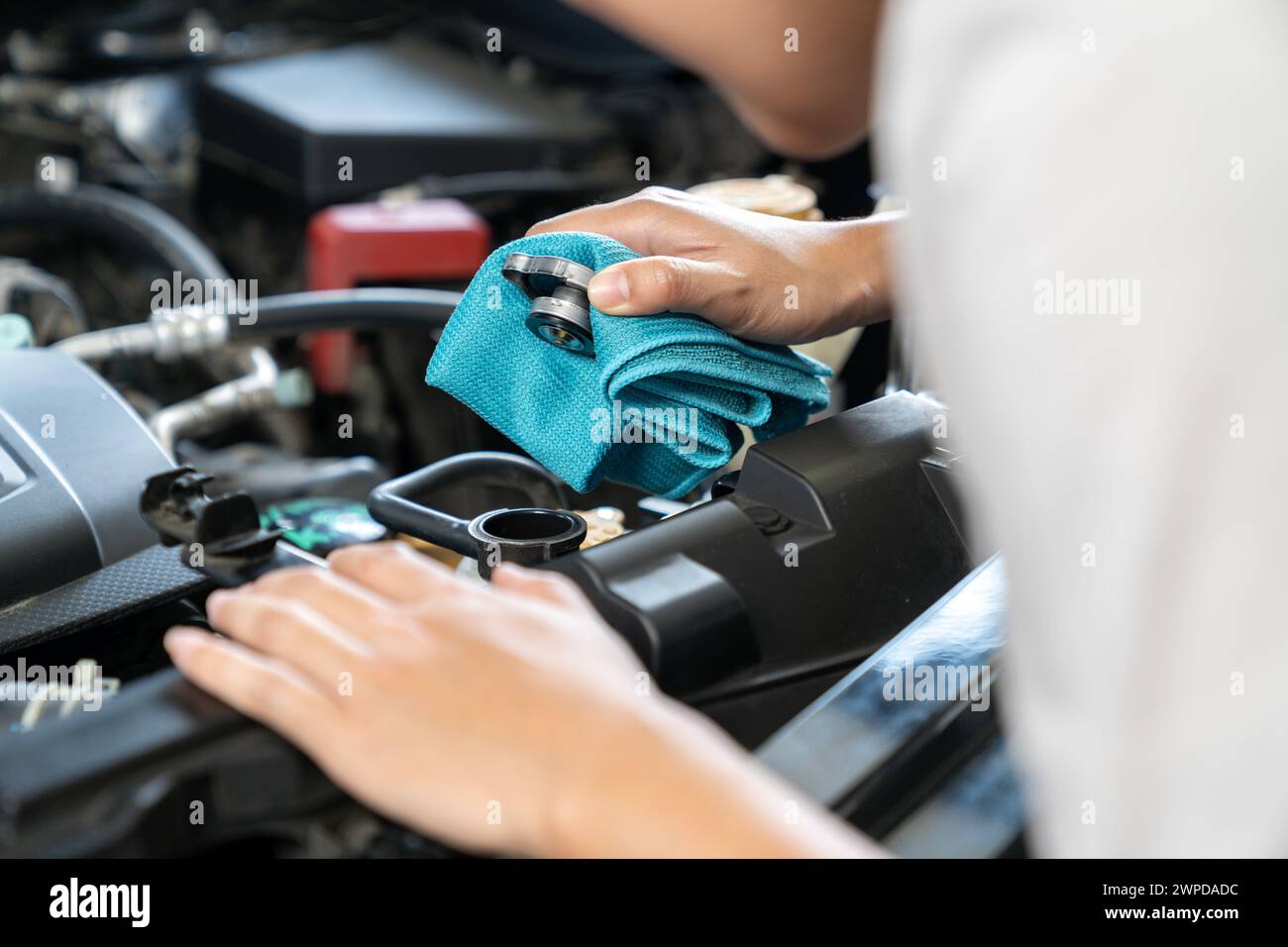 The young woman is opening cooling water, Check open radiator cap Stock ...