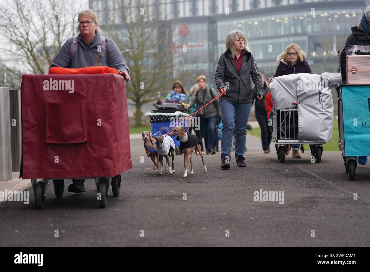 Dogs and owners arrive on the first day of the Crufts Dog Show at the ...