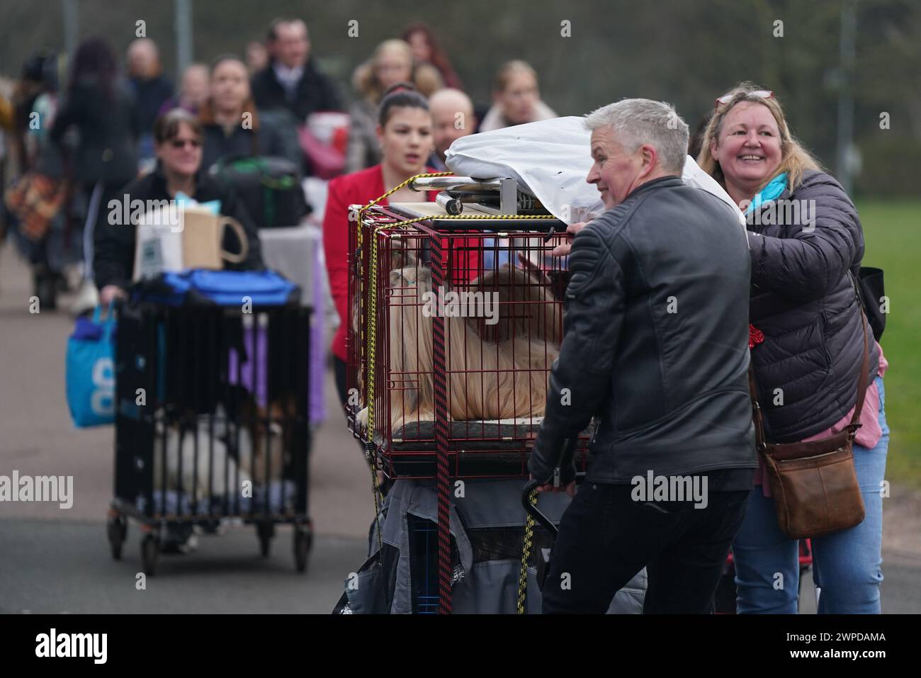 Dogs and owners arrive on the first day of the Crufts Dog Show at the ...