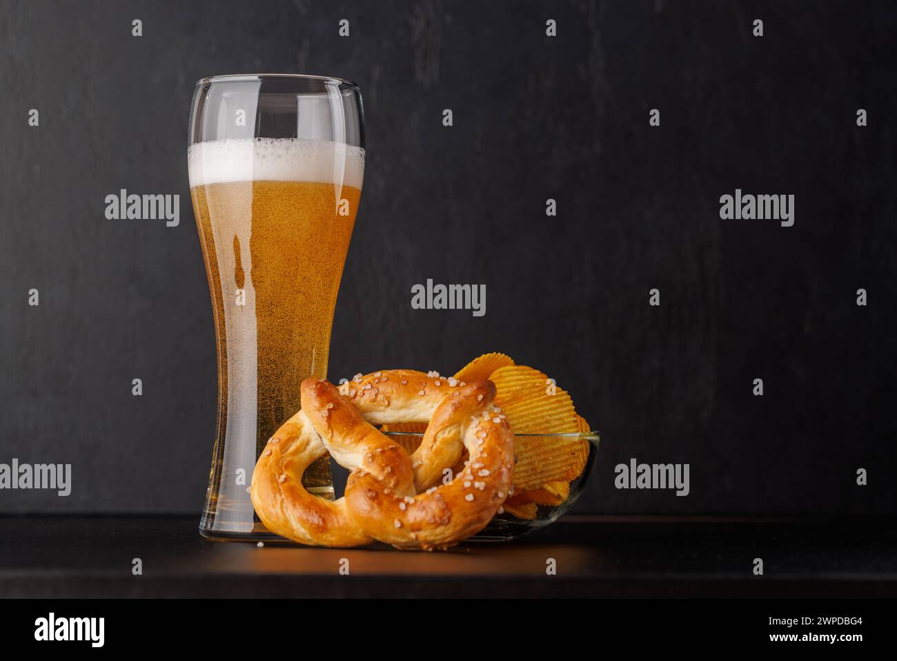 Beer, chips and pretzel. Over dark background with copy space Stock ...