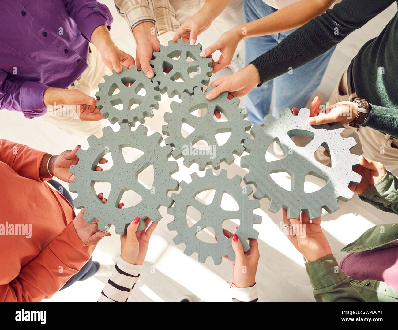 Group Of People Holding Gear, Cog Wheels Stock Photo - Alamy