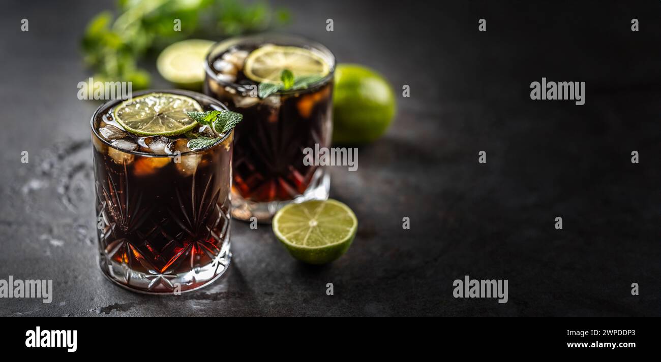 Tropical alcoholic cocktail Cuba Libre composed of white rum, cola, ice ...