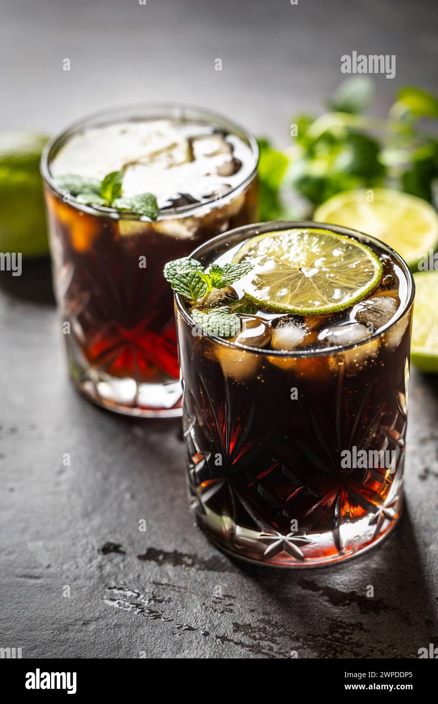 Tropical alcoholic cocktail Cuba Libre composed of white rum, cola, ice ...