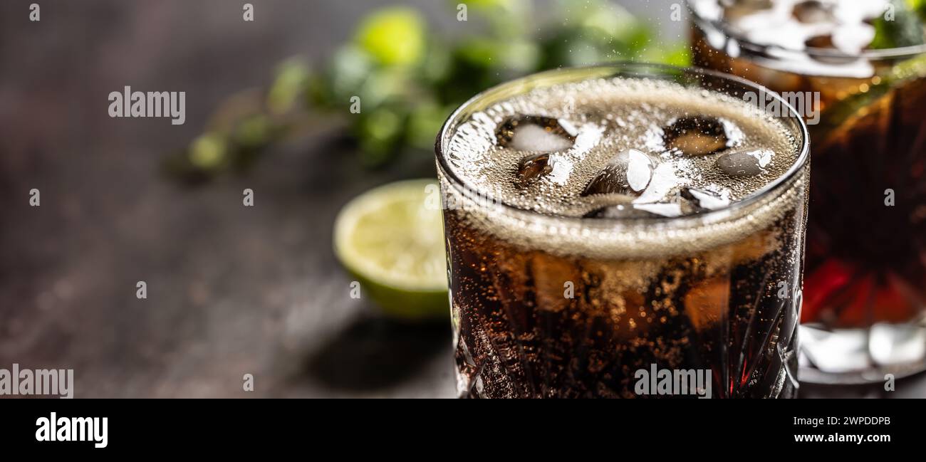 Bubbling Coke drink with ice cubes on the bar counter Stock Photo - Alamy
