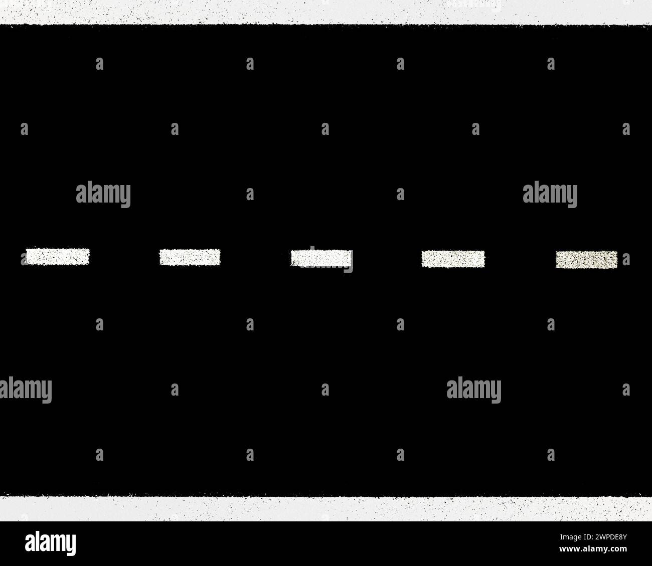 Aerial view of black asphalt with a white dashed dividing line and ...