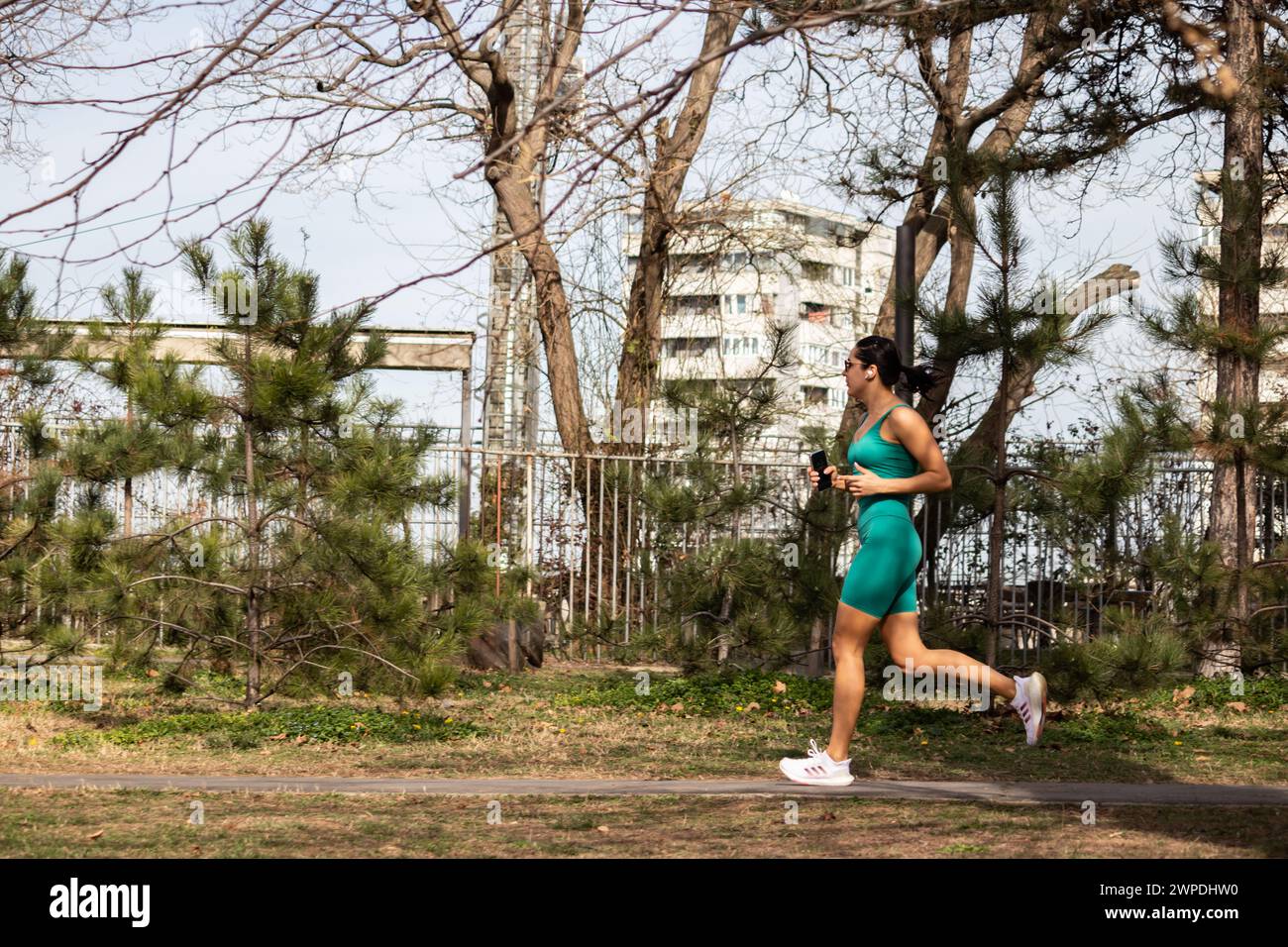 Fit good looking girl jogging in green park in the morning, healthy ...