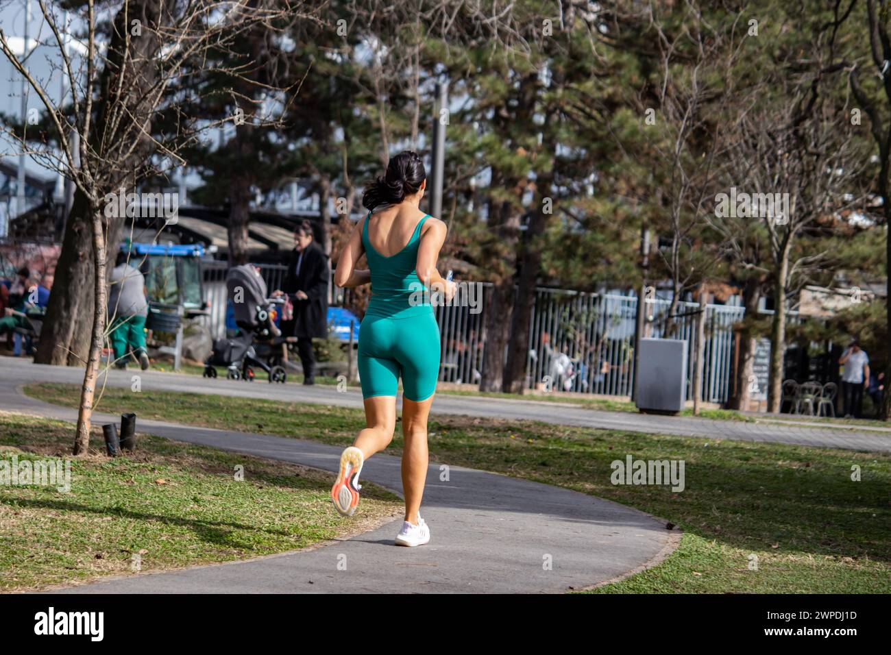 Fit good looking girl jogging in green park in the morning, healthy ...