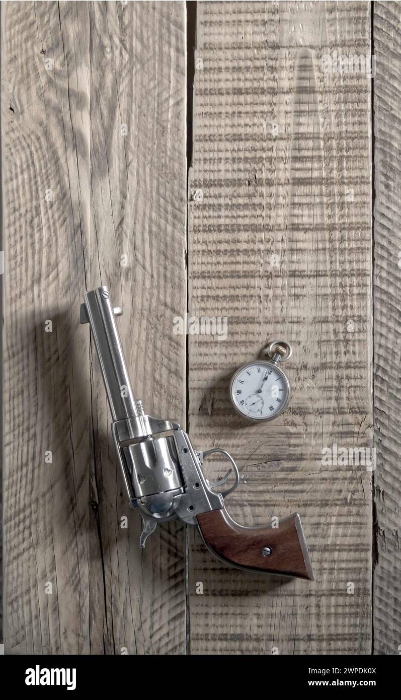 Wild west cowboys six gun, revolve, and pocket watch showing 12 noon ...