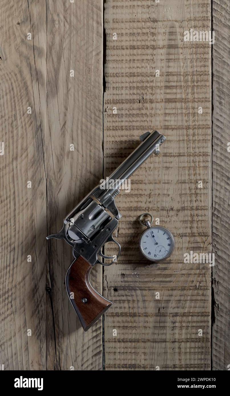 Wild west cowboys six gun, revolve, and pocket watch showing 12 noon ...