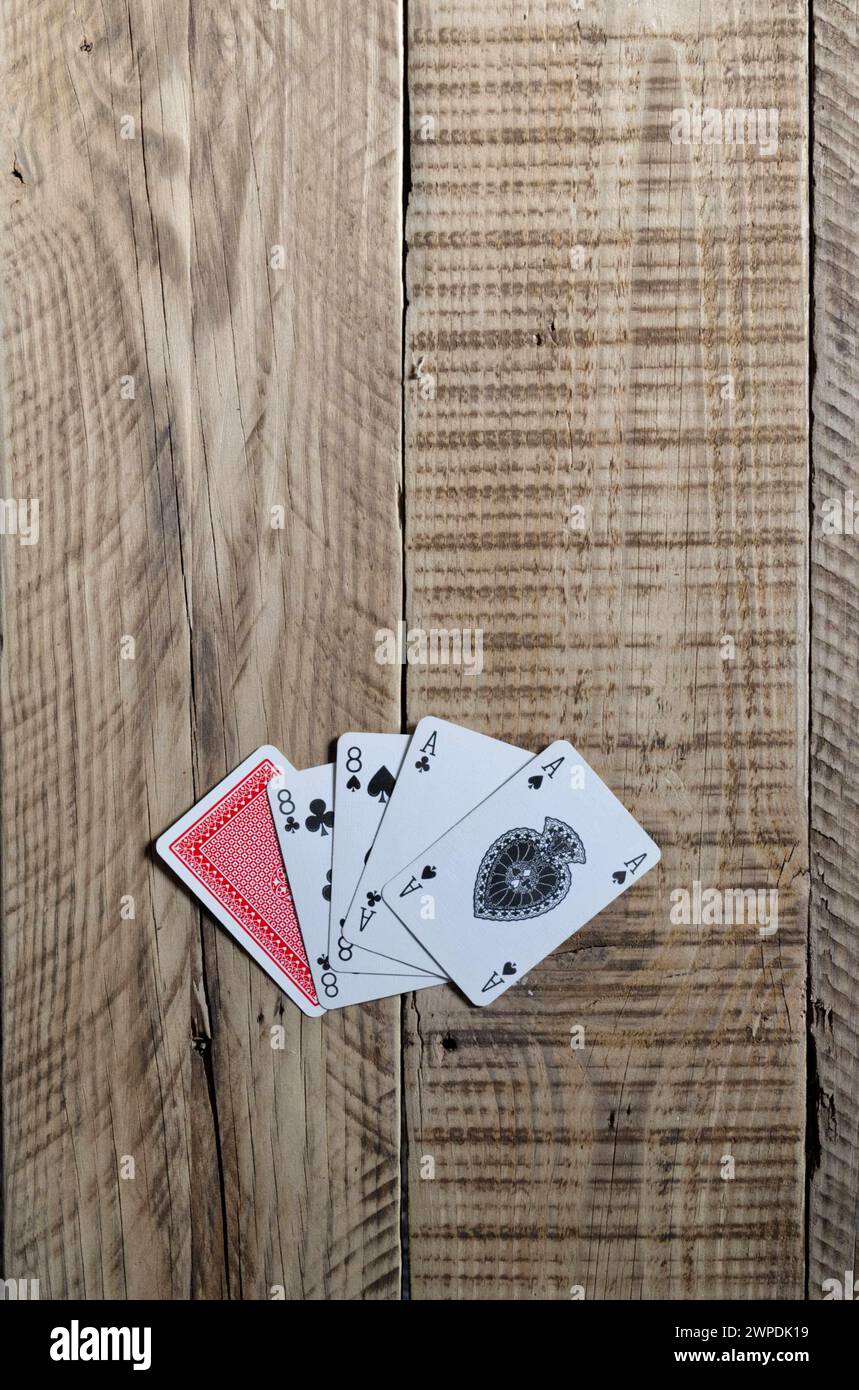 Dead mans hand playing cards aces and eights on wooded background Stock ...