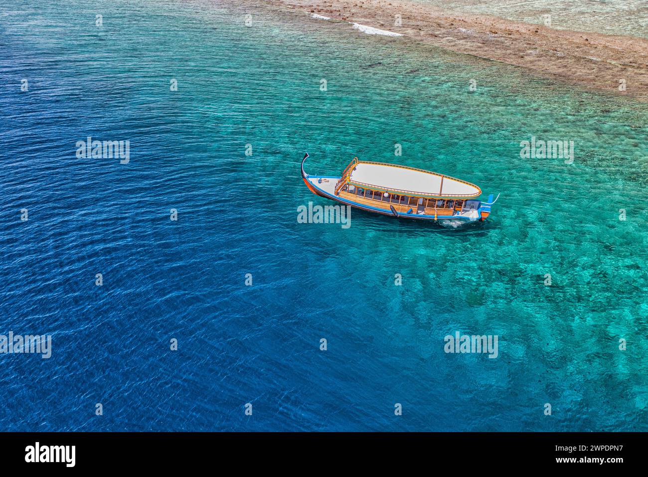 Beach and crystal clear lagoon with white boat. Turquoise water ...