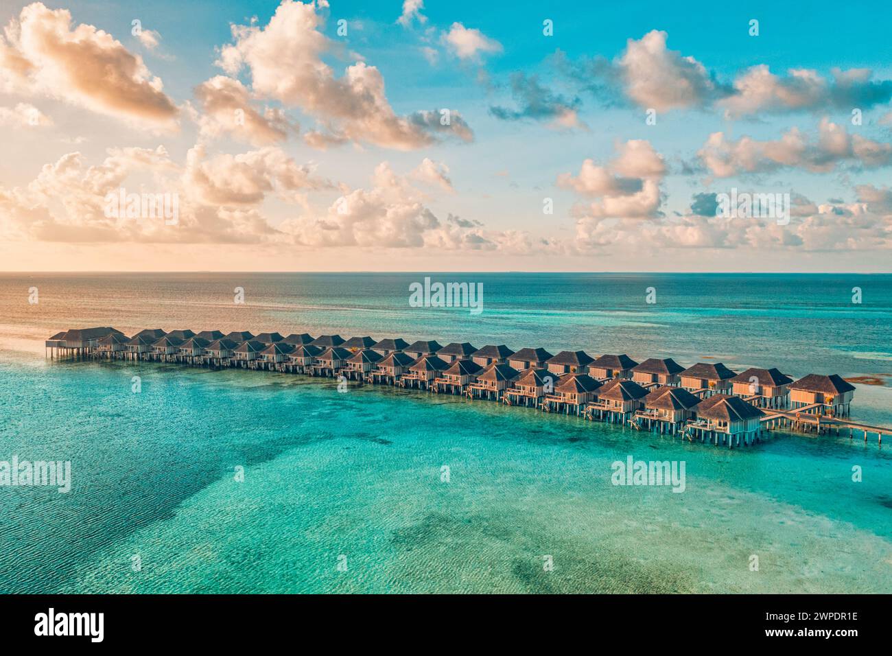 Aerial sunset panoramic landscape luxury tropical resort water villa ...