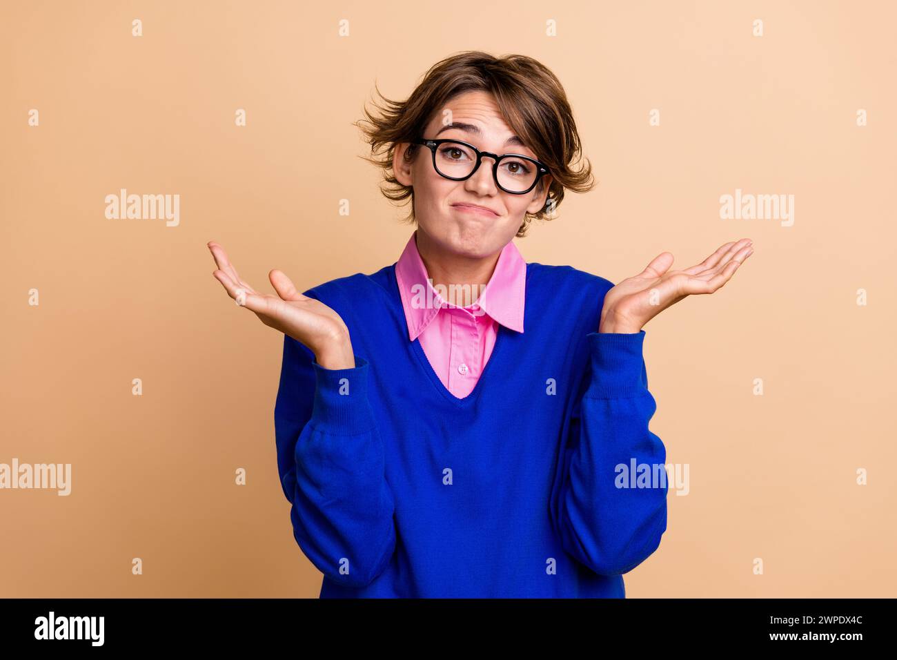 Photo of questioned clueless person raise arms palms shrug shoulders do ...